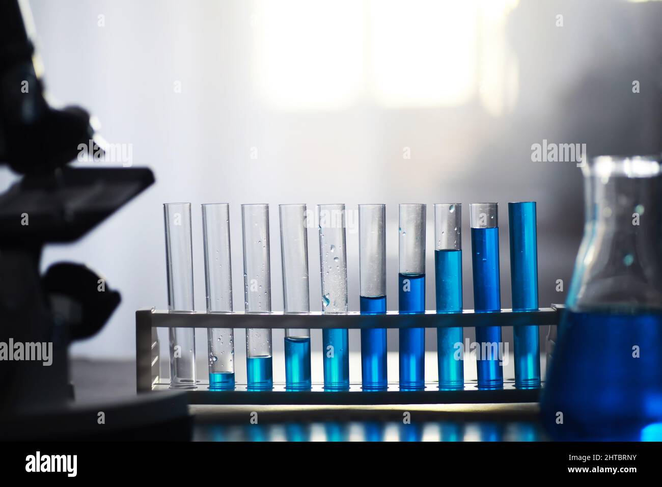 Test tube with blue liquid on laboratory table. Examination of liquid ...