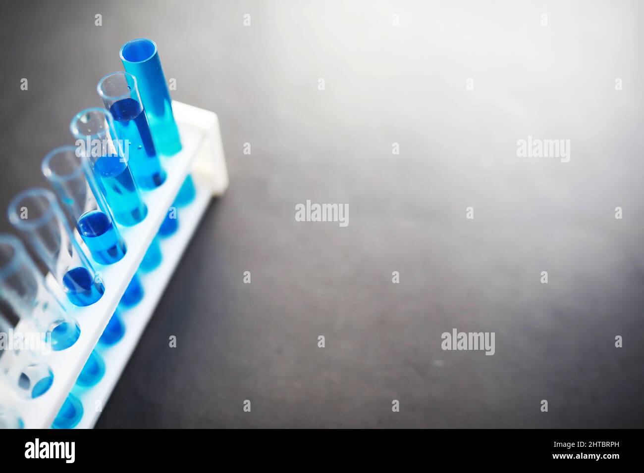 Test tube with blue liquid on laboratory table. Examination of liquid ...