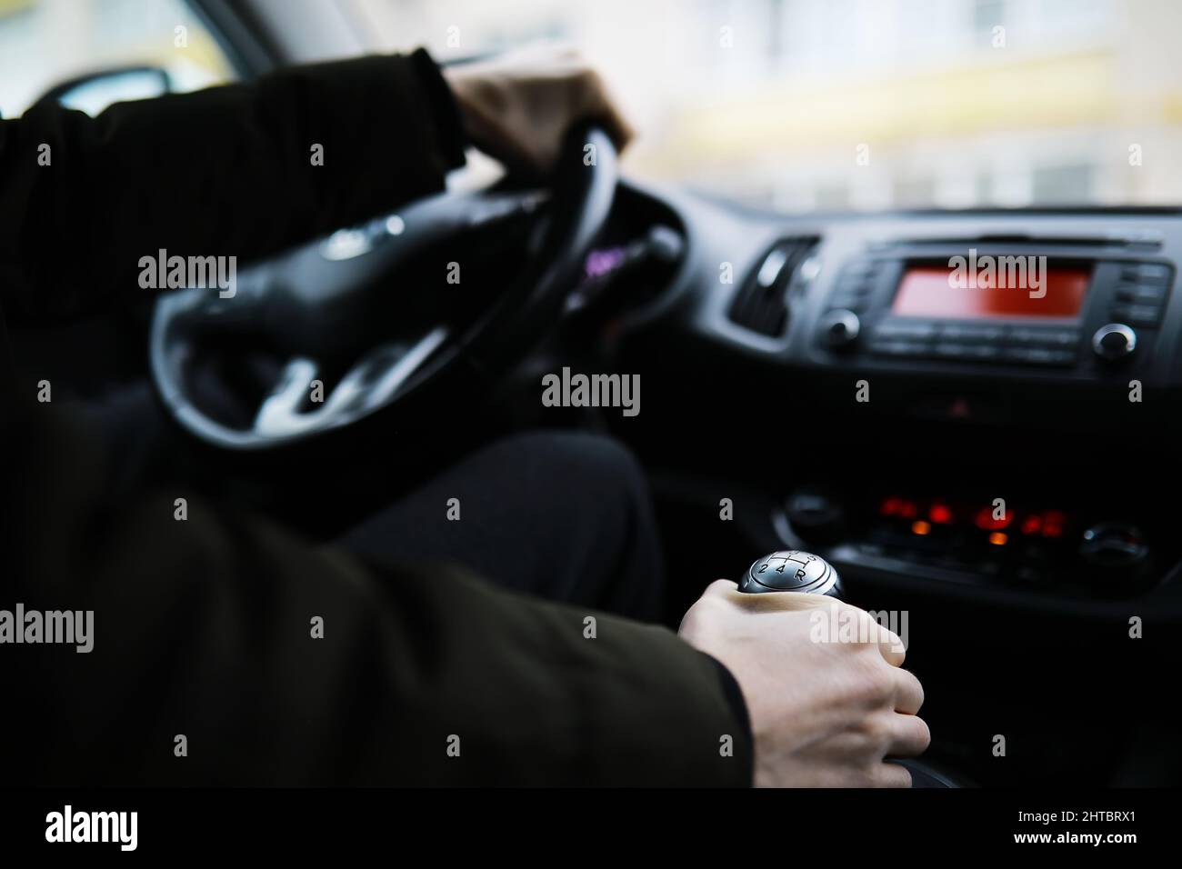 Hand on car gear knob. The driver switches the speed in the car. Hand ...