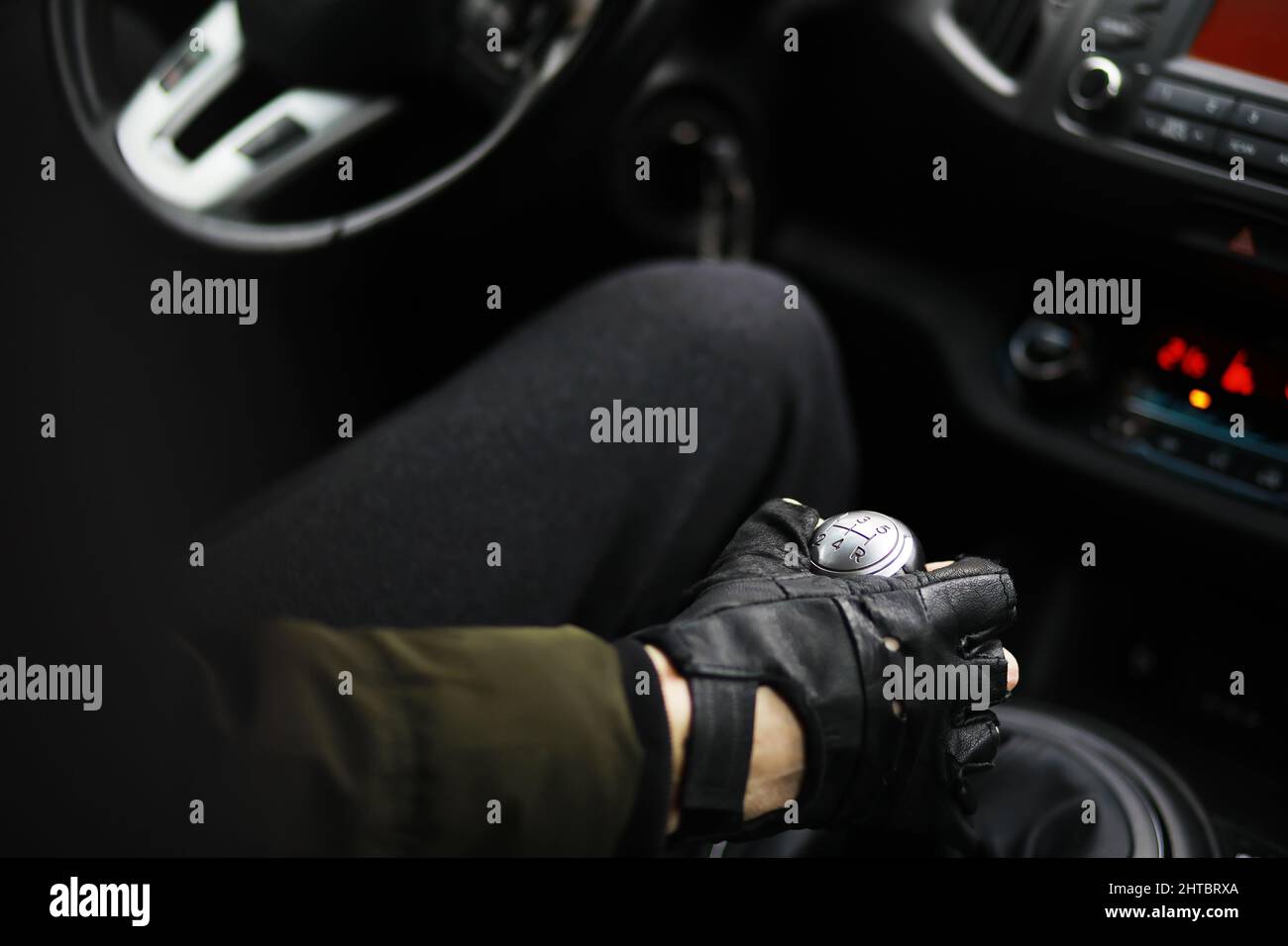 Hand on car gear knob. The driver switches the speed in the car. Hand ...