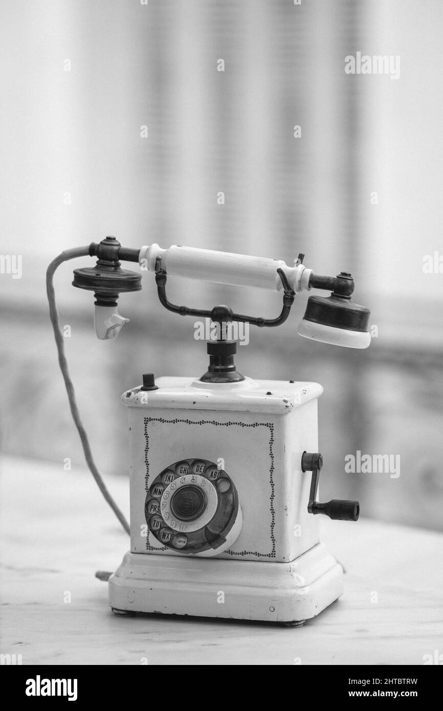 Vertical shot of an antique telephone in grayscale Stock Photo - Alamy