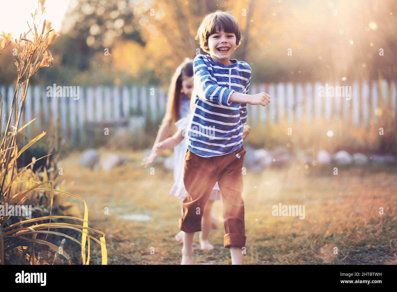 Children walk in the summer in nature. Child on a sunny spring morning ...