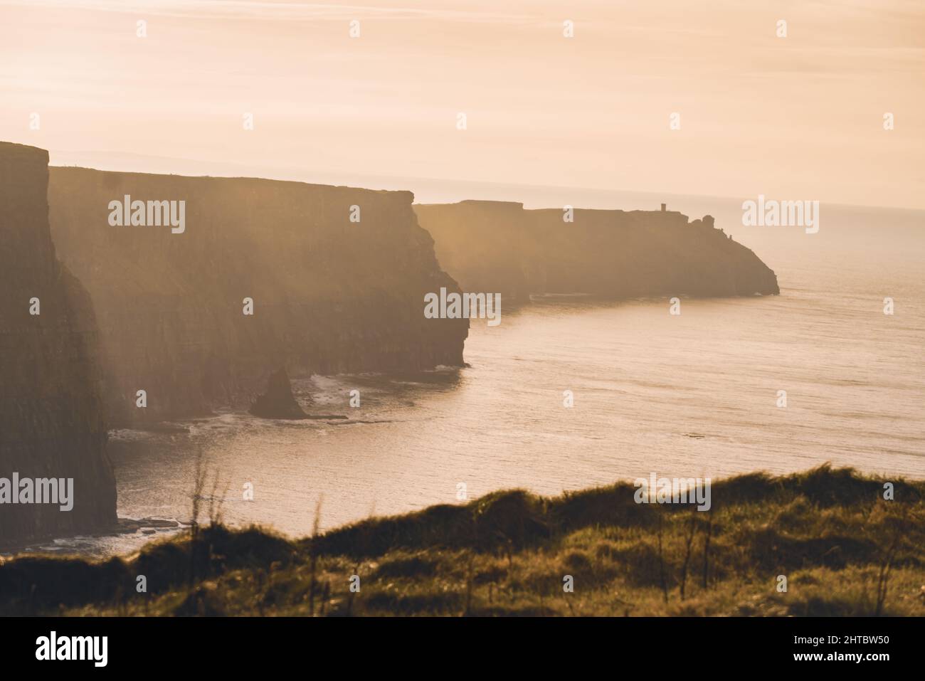 Scenery of sea with cliffs on the shore at sunset or sunrise Stock ...