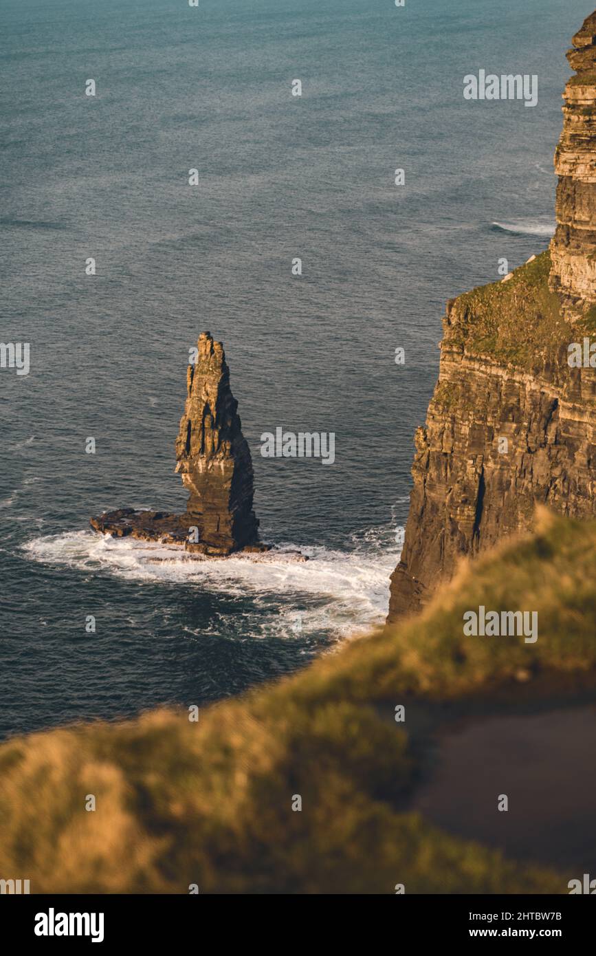 Scenery of sea with a rock and cliffs on the shore Stock Photo - Alamy