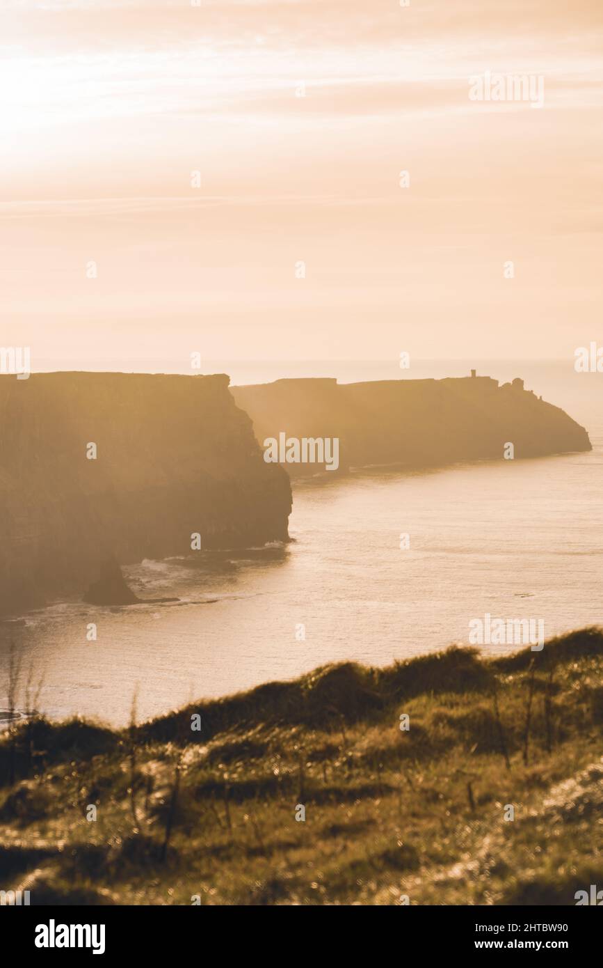 Scenery of sea with cliffs on the shore at sunset or sunrise Stock ...