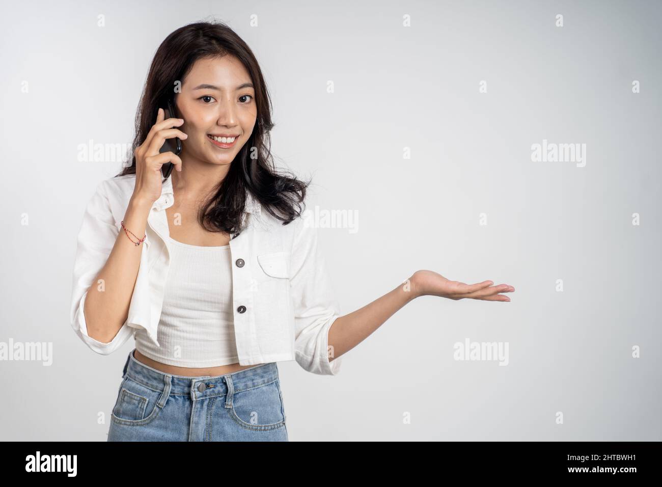 woman make a call with hand gesture presenting Stock Photo - Alamy