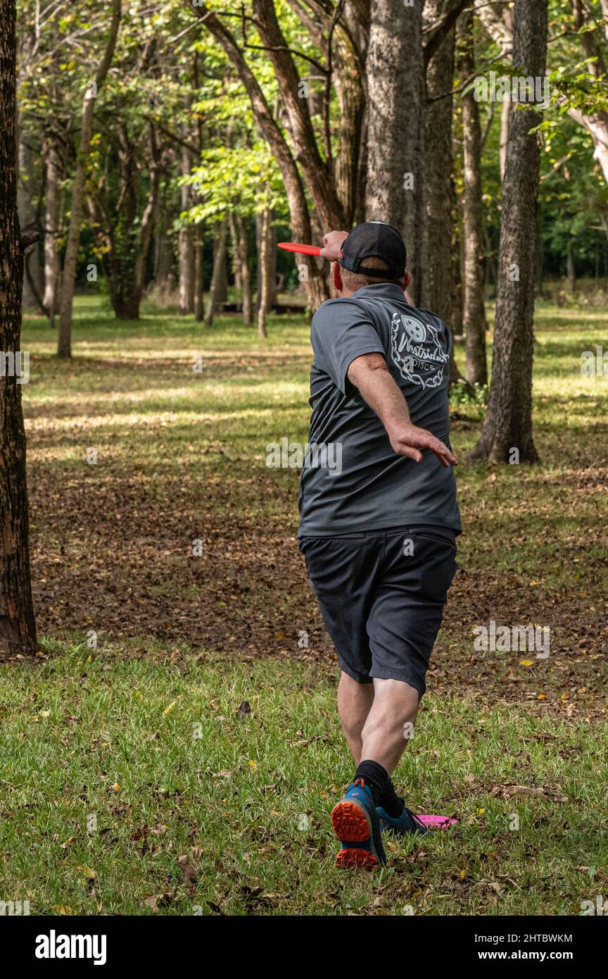 Man playing disc frisbee golf Stock Photo - Alamy