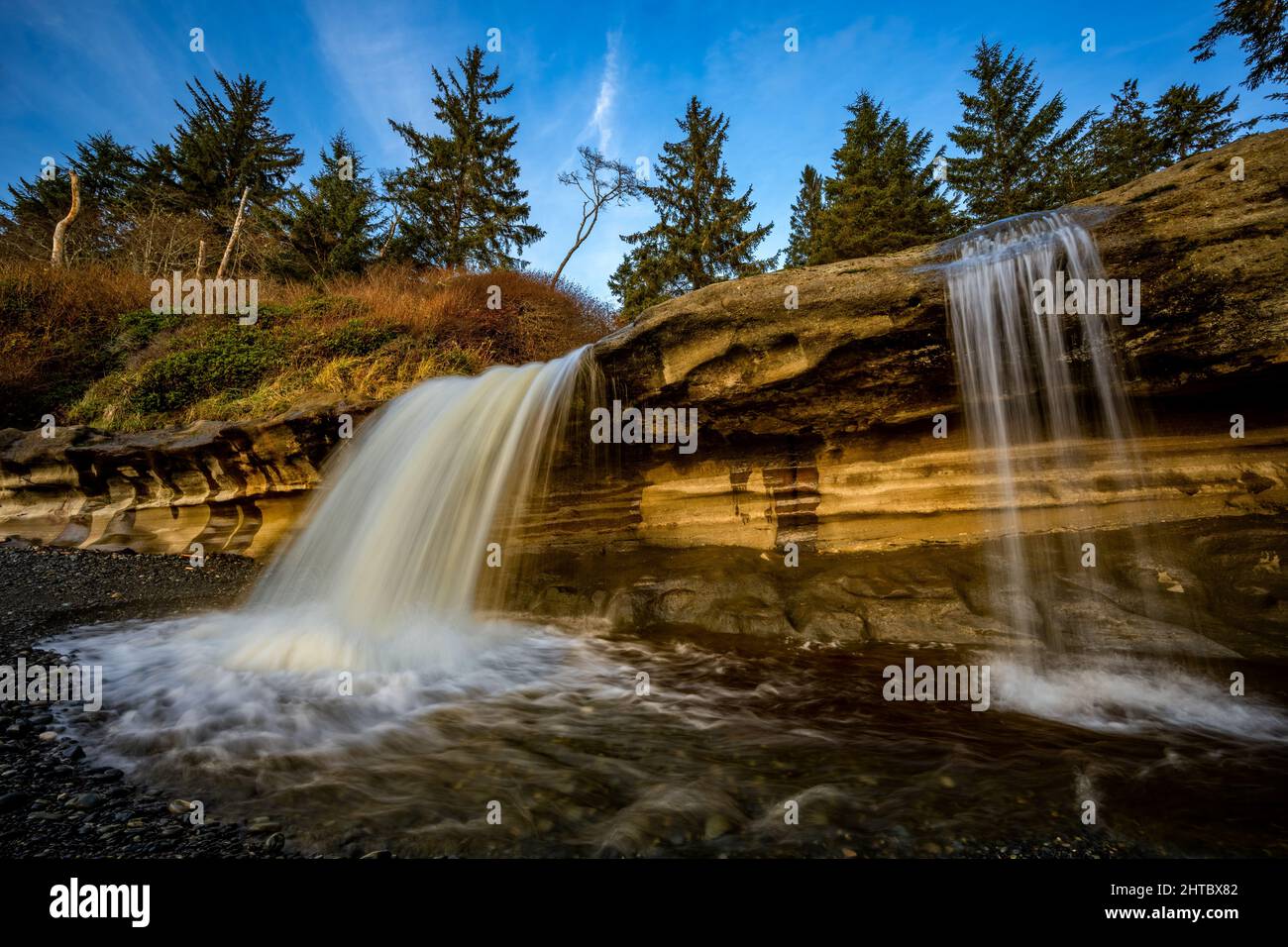 Beautiful waterfall flowing down from huge cliffs Stock Photo - Alamy