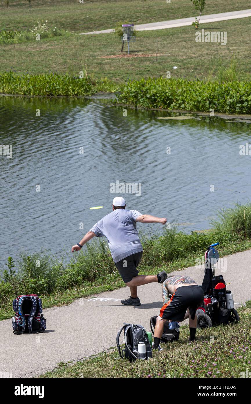 Man playing disc frisbee golf Stock Photo - Alamy