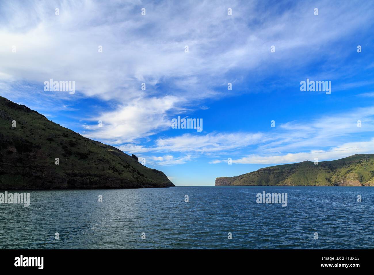The entrance to Akaroa Harbour on Banks Peninsula, New Zealand, between ...
