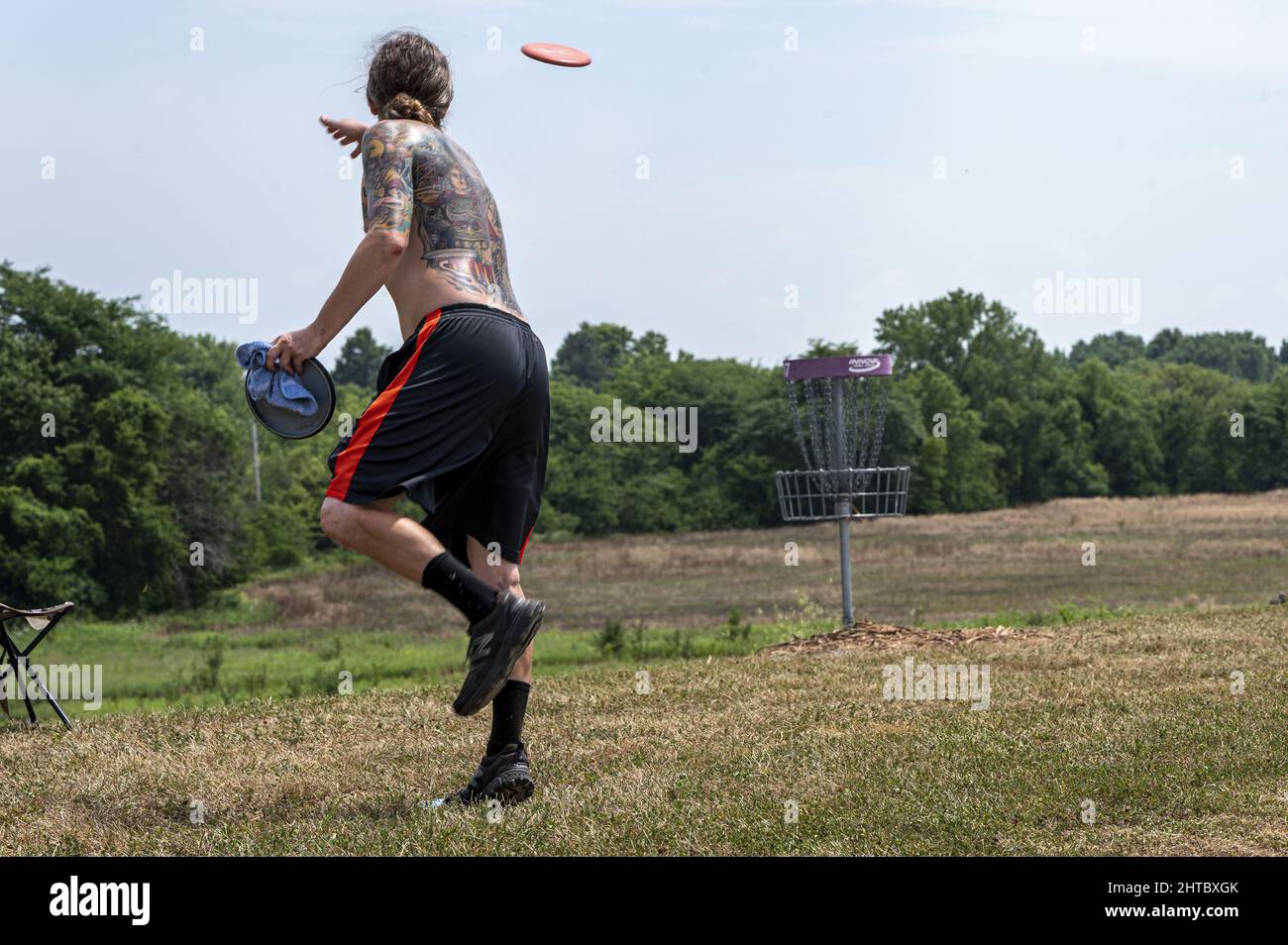 Man playing disc frisbee golf Stock Photo - Alamy