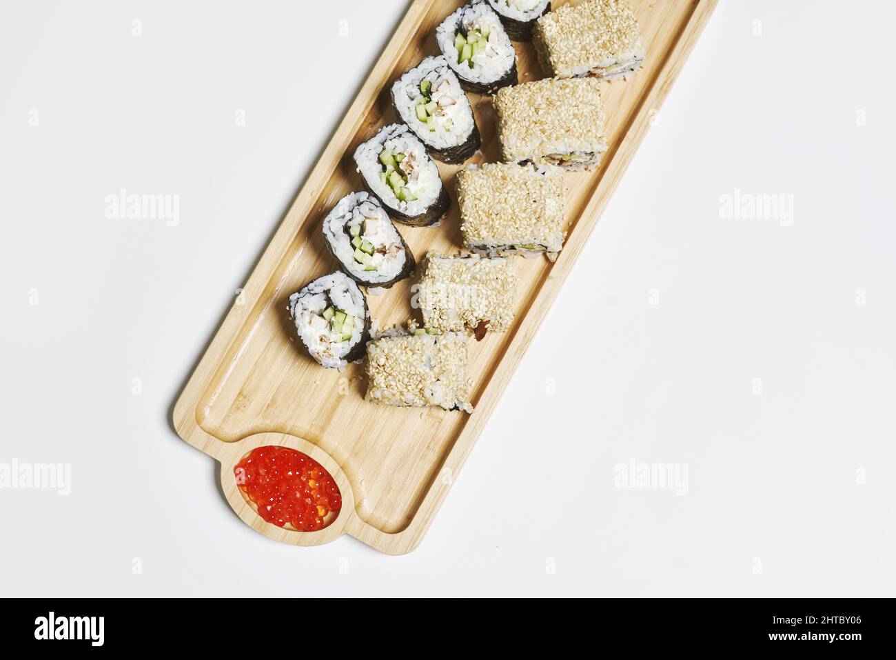 A top view of rolled sushi on a wooden stand isolated on white ...