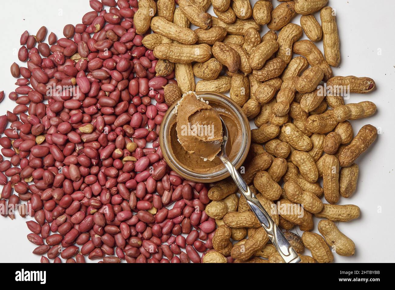 Closeup shot of peanut butter and peanuts on a white background Stock ...