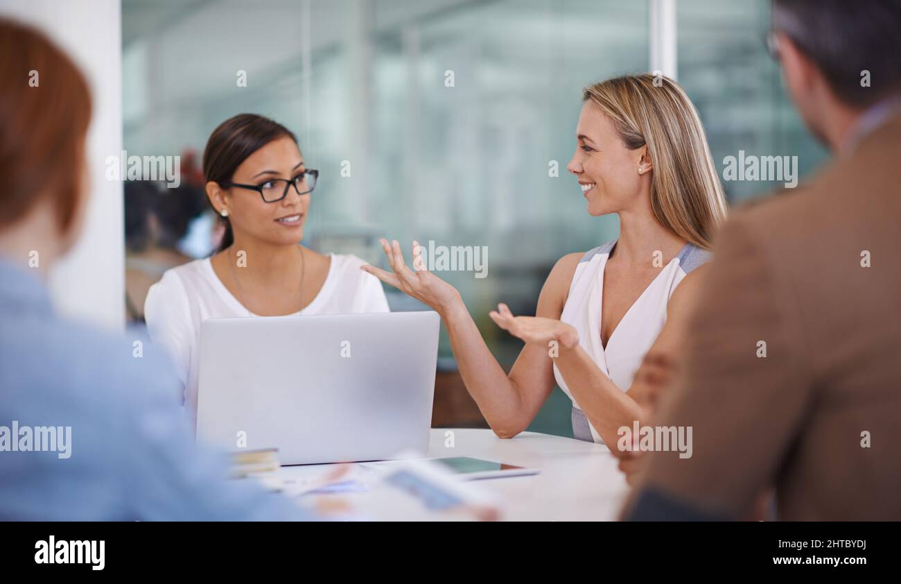 Its splendidly simple. Shot of two female colleagues discussing ideas ...