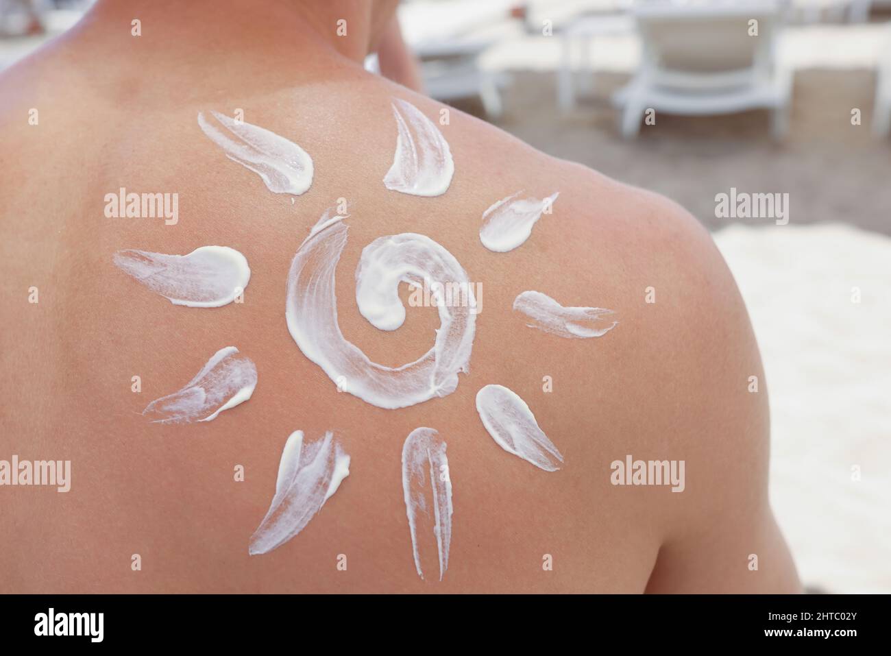 Persons back with sunscreen picture of sun on it, protect skin from ...