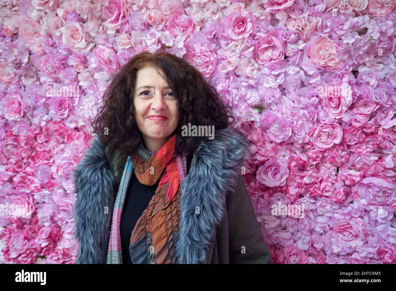 Portrait of a Beautiful girl with thousands of roses on the background ...
