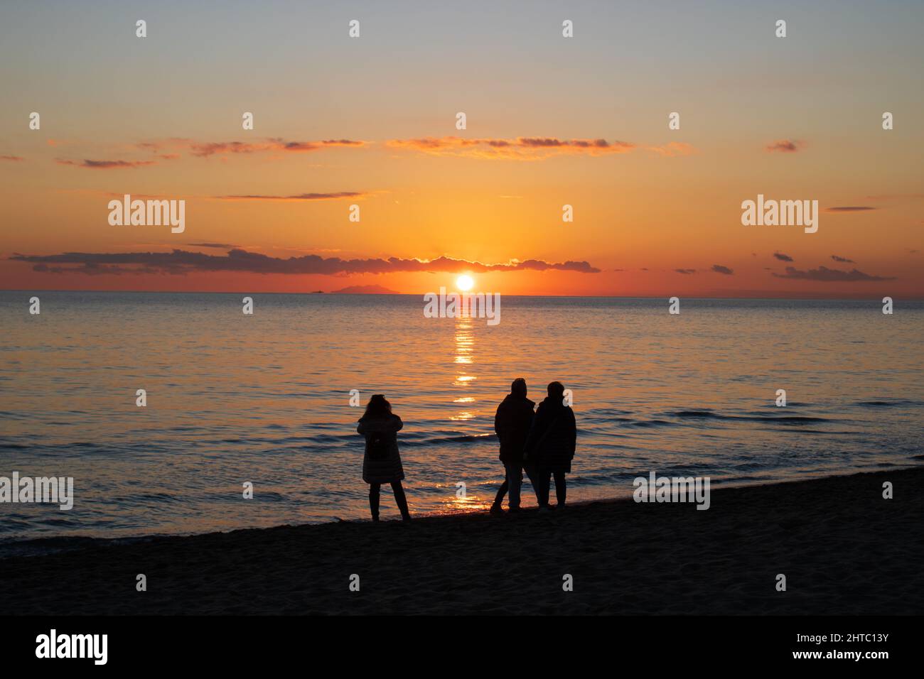 Two peolple walking on a beach under sunset. High quality photo Stock ...