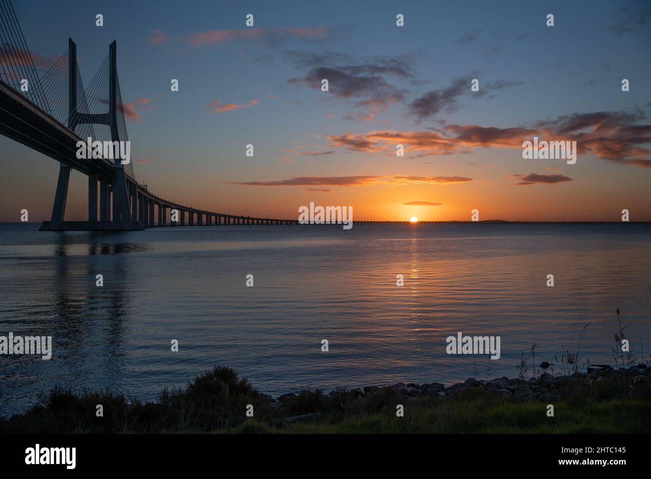 Beautiful view of a bridge on the water in Lisbon, Portugal Stock Photo ...