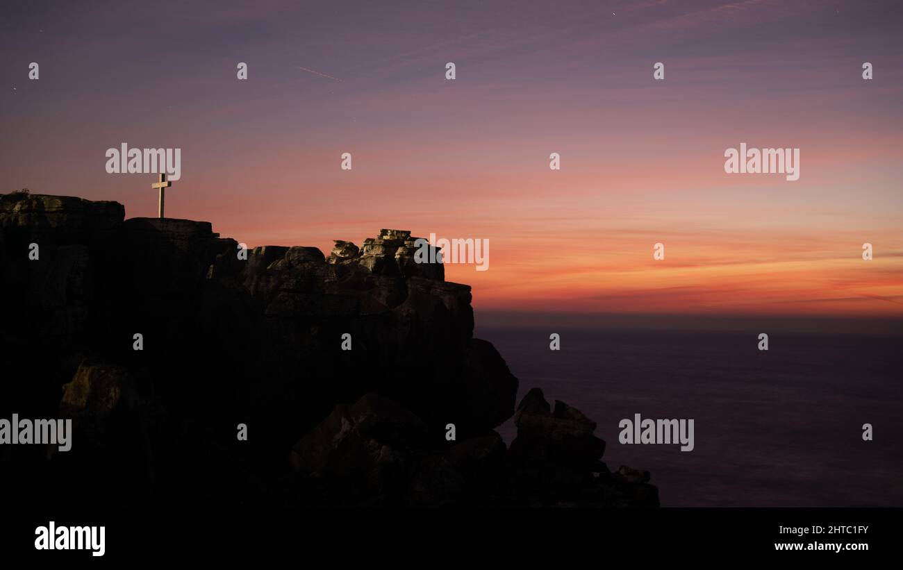 Beautiful view of a cross on a picturesque rock after sunset Stock ...