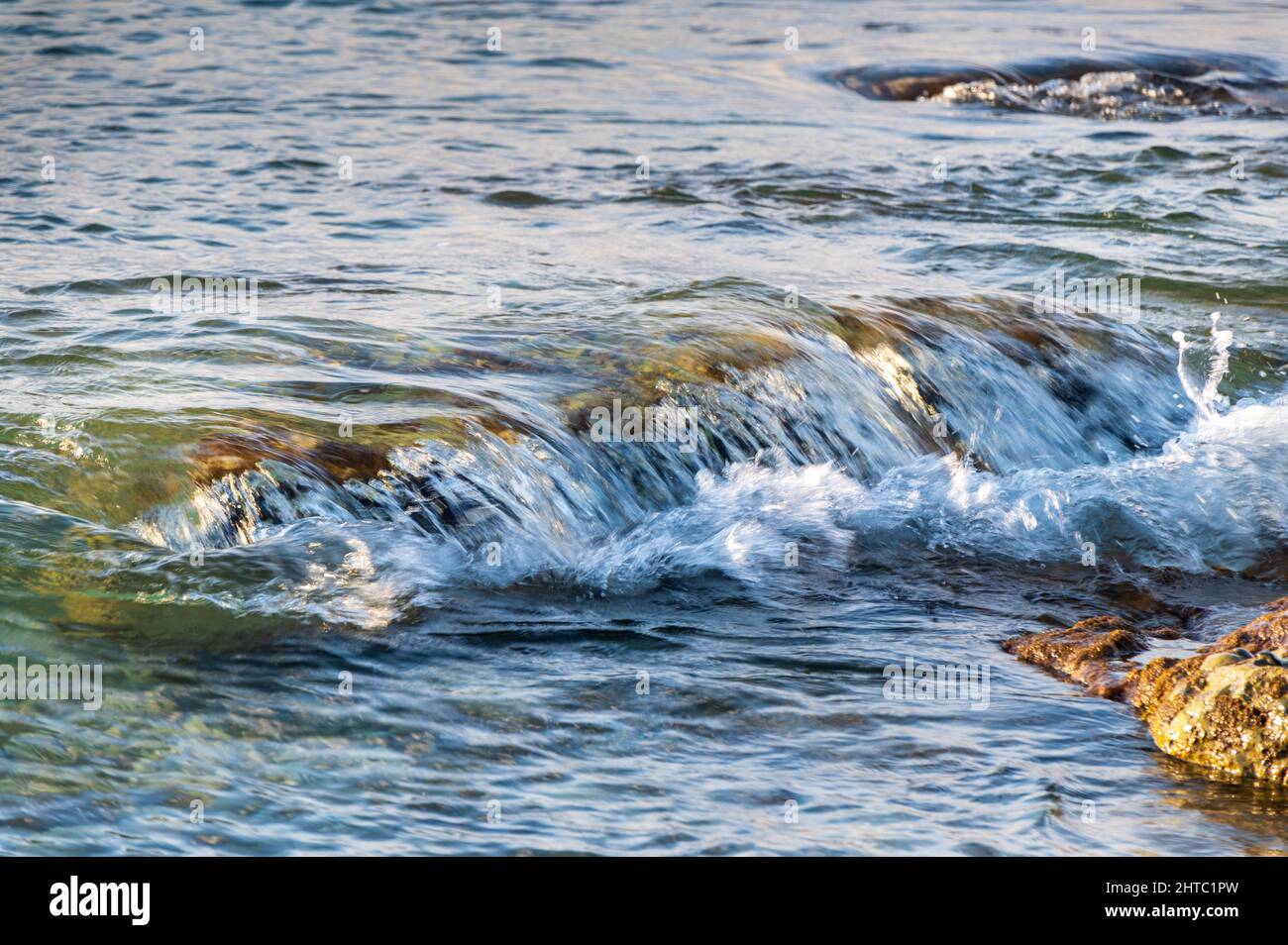 Waves splashing on the shore Stock Photo - Alamy