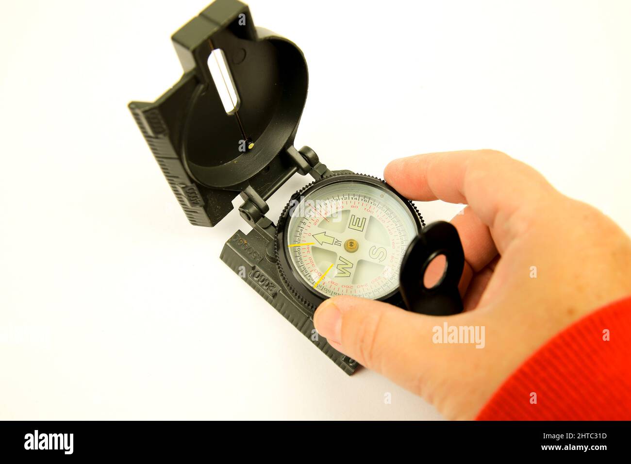 Hand holding a Military green compass on white background Stock Photo ...