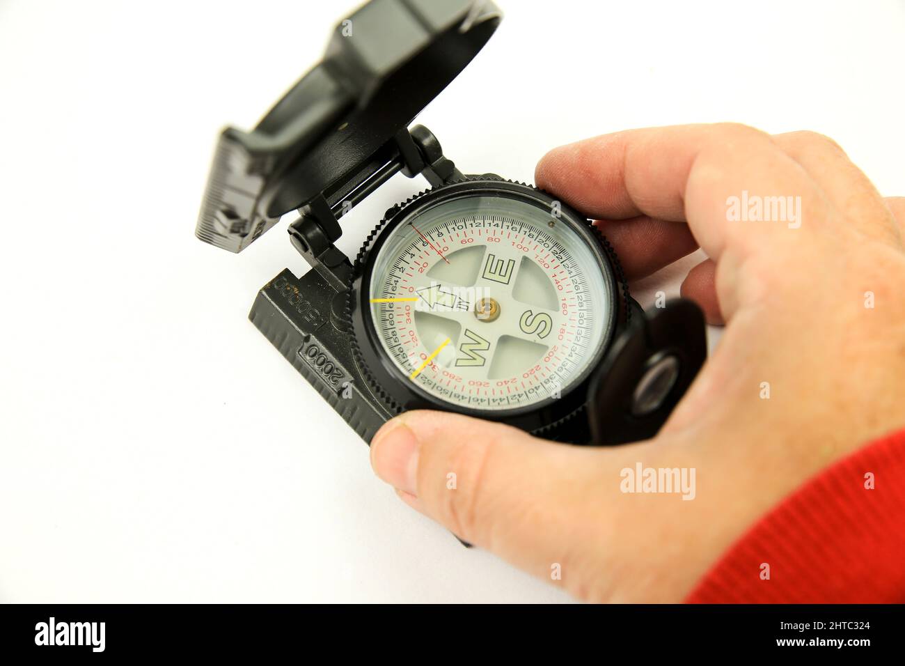 Hand holding a Military green compass on white background Stock Photo ...