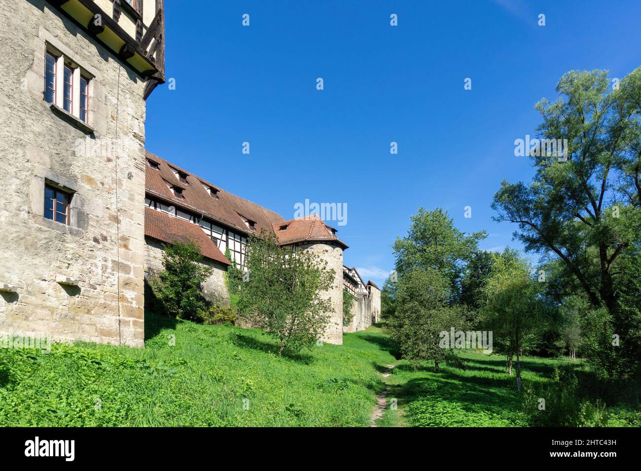 Half-timbered houses surrounded by greenery under the sunlight in south ...