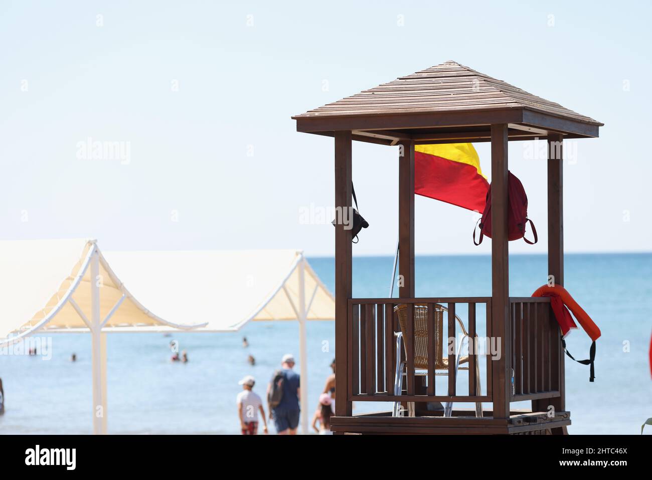 Beach with baywatch tower, no lifeguard person on post, people swimming ...