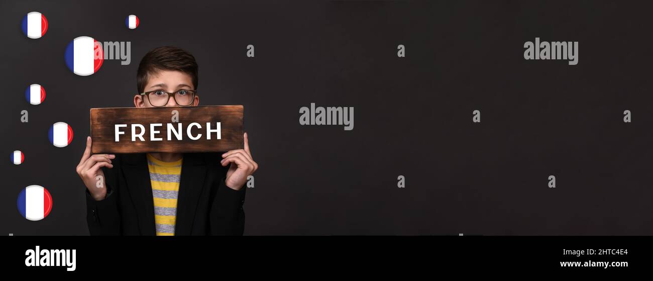 learning French. banner on a black background. a teenager holds an ...