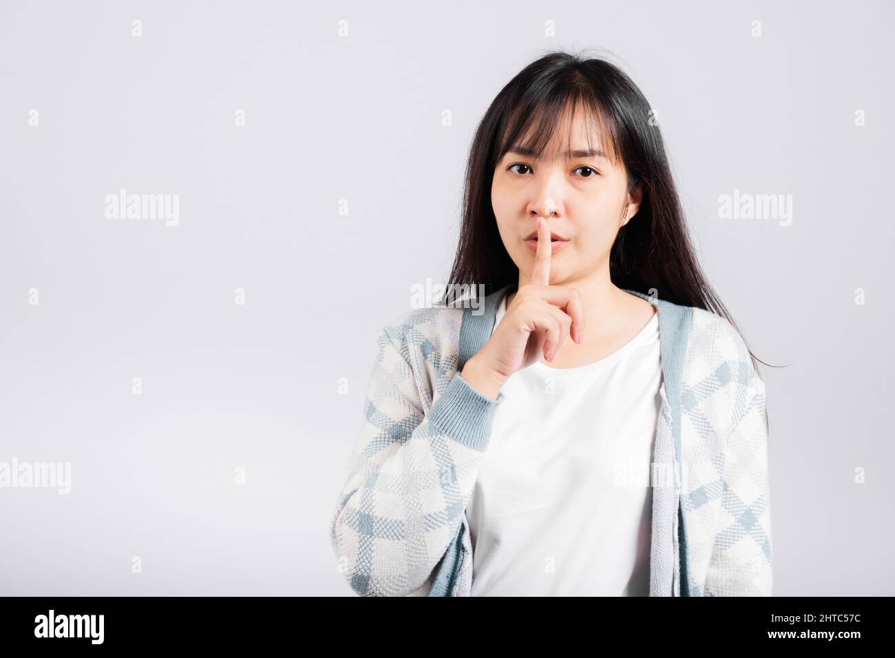 Woman making finger on lips mouth silent quiet gesture, Happy Asian ...