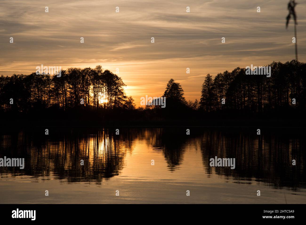 Beautiful landscape sunset view over reflecting lake water with trees ...