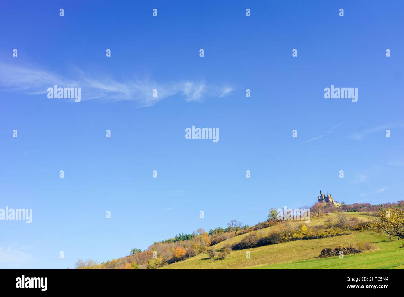 Distant view of the famous Hohenzollern castle under a blue sky on a ...