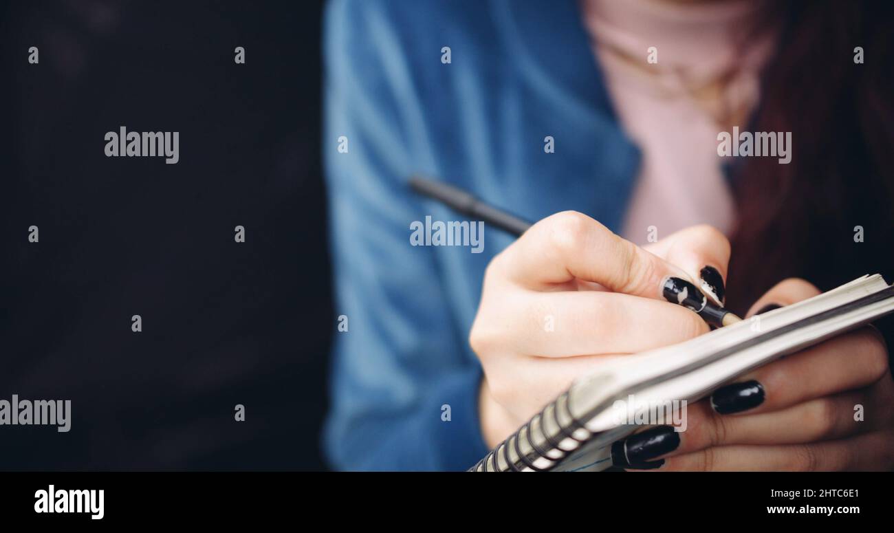 Woman writing on the notebook Stock Photo - Alamy