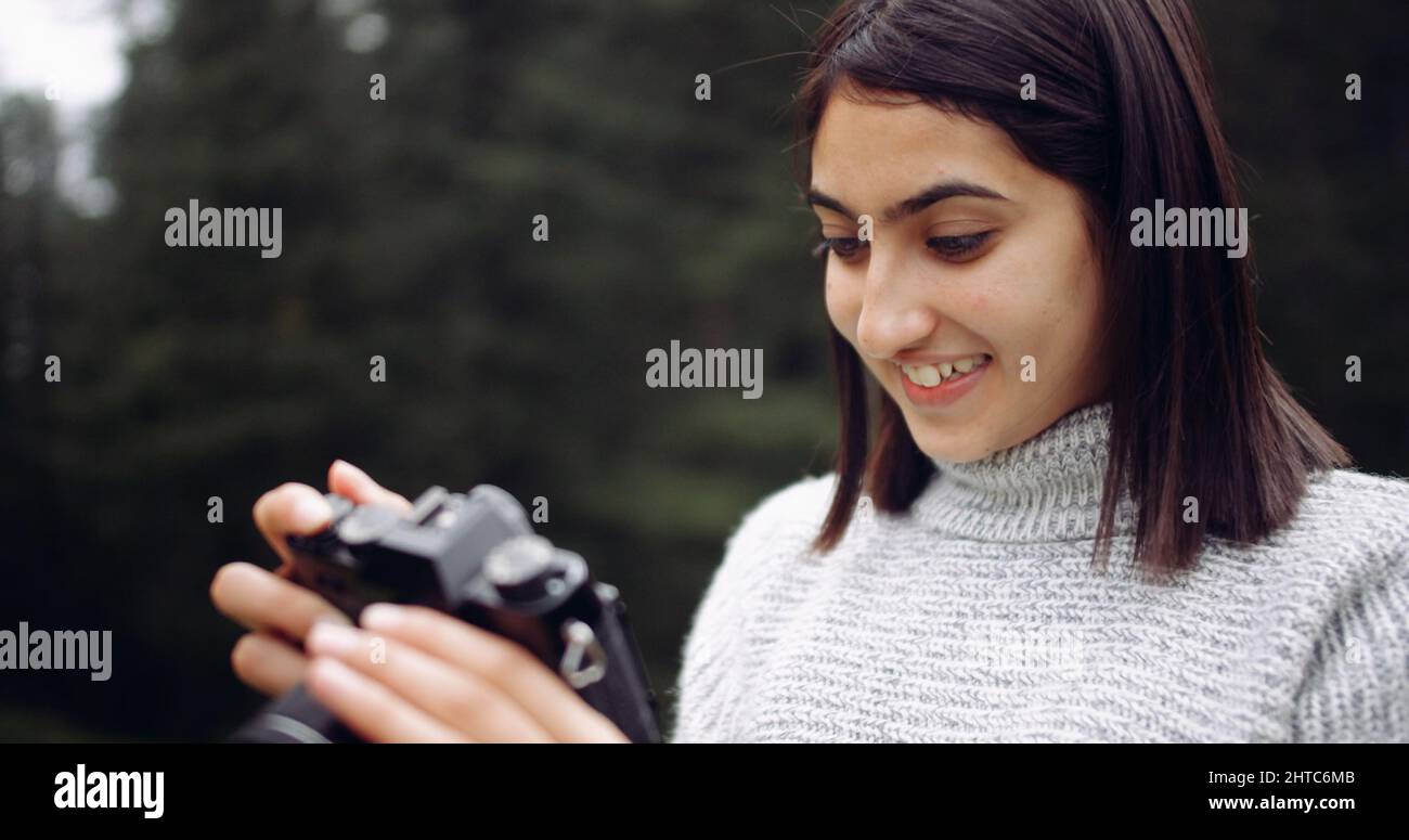 Young South Asian girl smilingly looking at the camera against a ...
