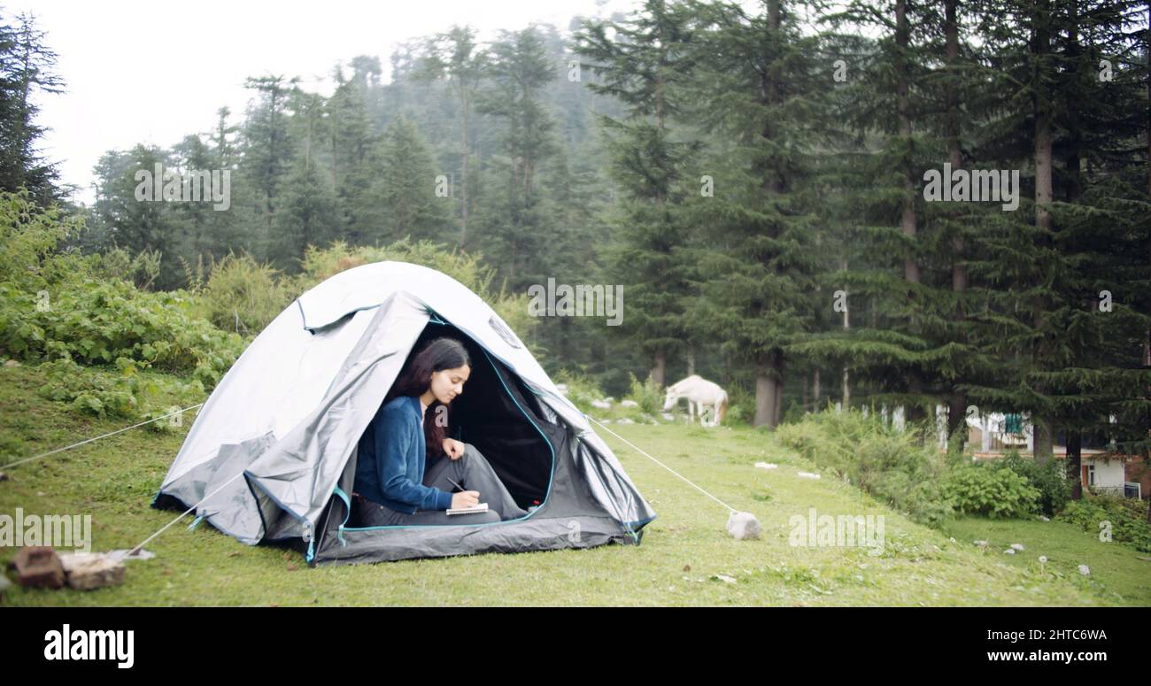 Young Indian girl in a tent while hiking Stock Photo - Alamy