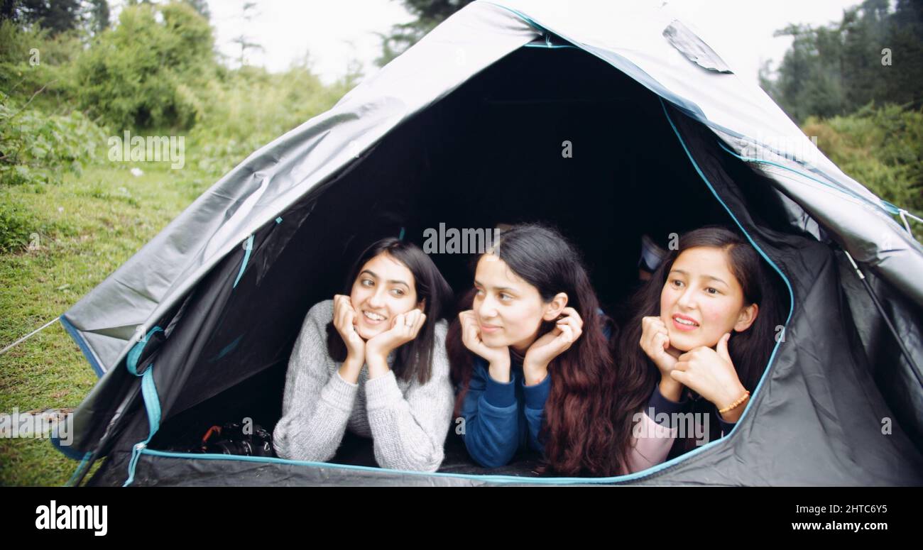 Friends having fun in a tent of the camp Stock Photo - Alamy