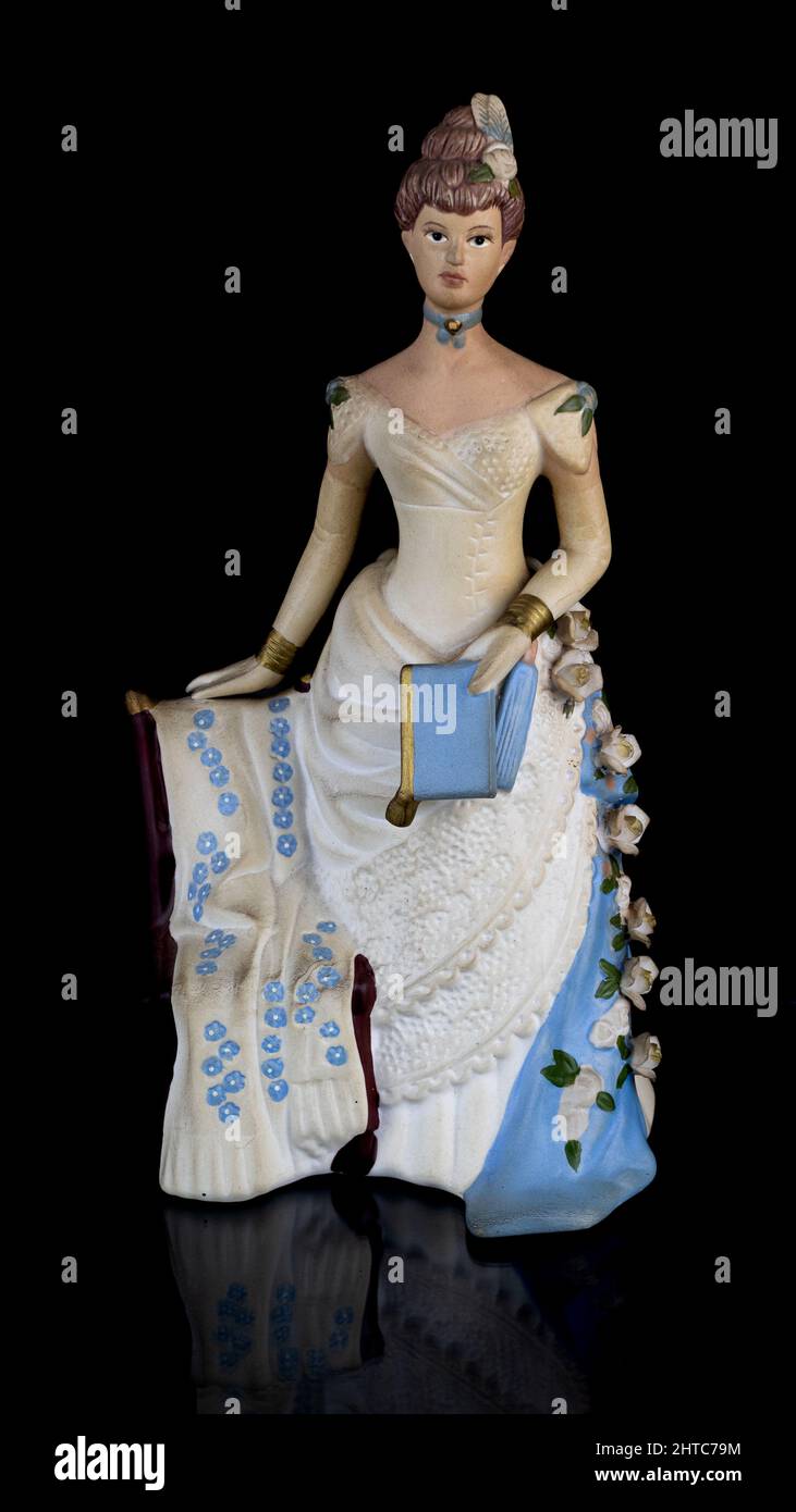 Vertical shot of a porcelain doll on a black background Stock Photo - Alamy