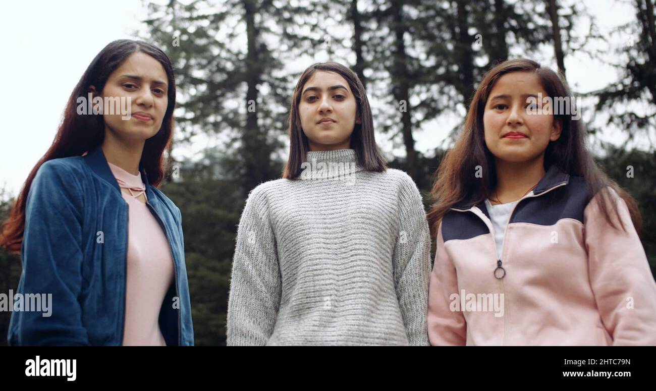 Young Indian girls standing in a pine forest Stock Photo - Alamy