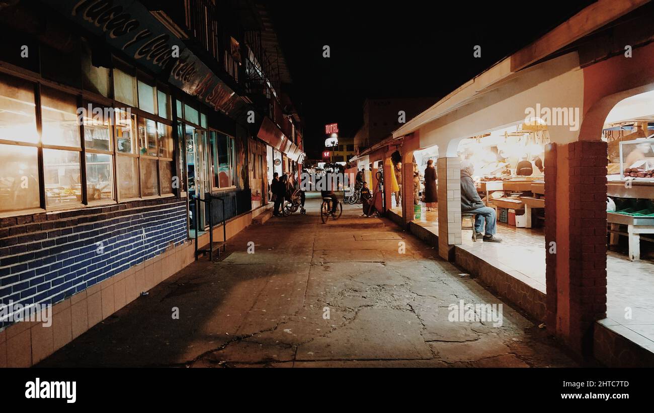Concrete street line with market stalls and shops at night Stock Photo ...