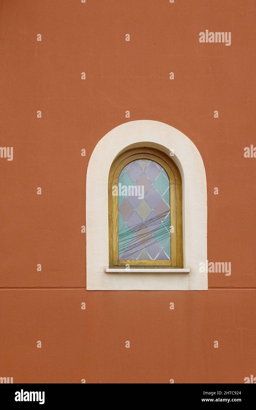 Closeup of a window on the facade of an orange building Stock Photo - Alamy
