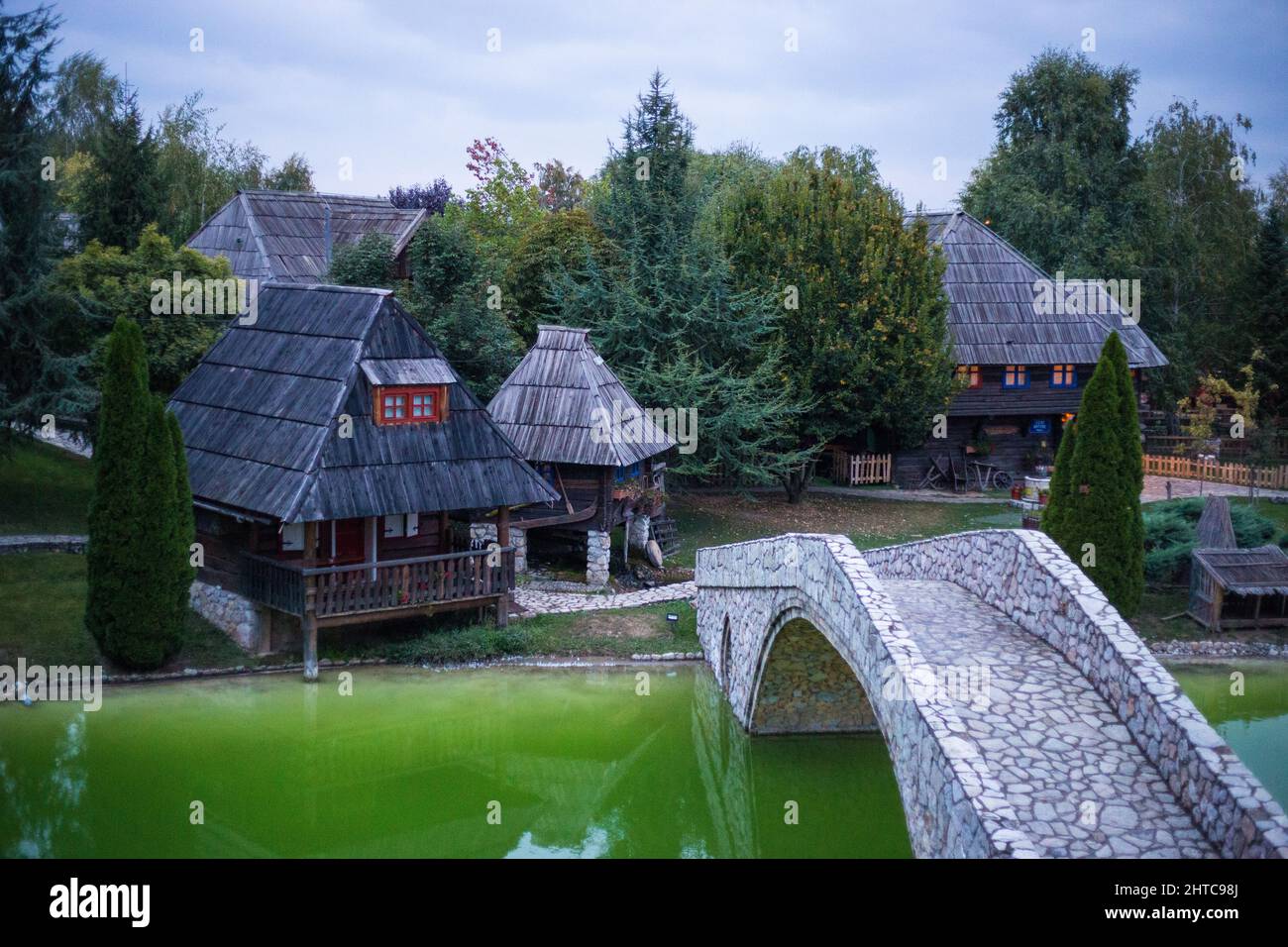 Beautiful stone bridge over the river in the village Stock Photo - Alamy