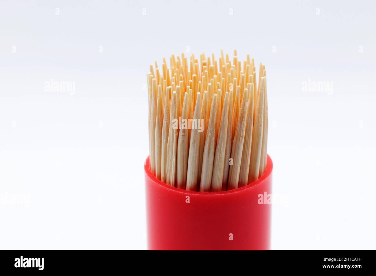 toothpicks in orange jar on white background Stock Photo - Alamy
