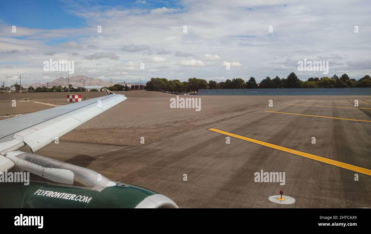 View of a frontier airlines aircraft wing on the tarmac prior to ...