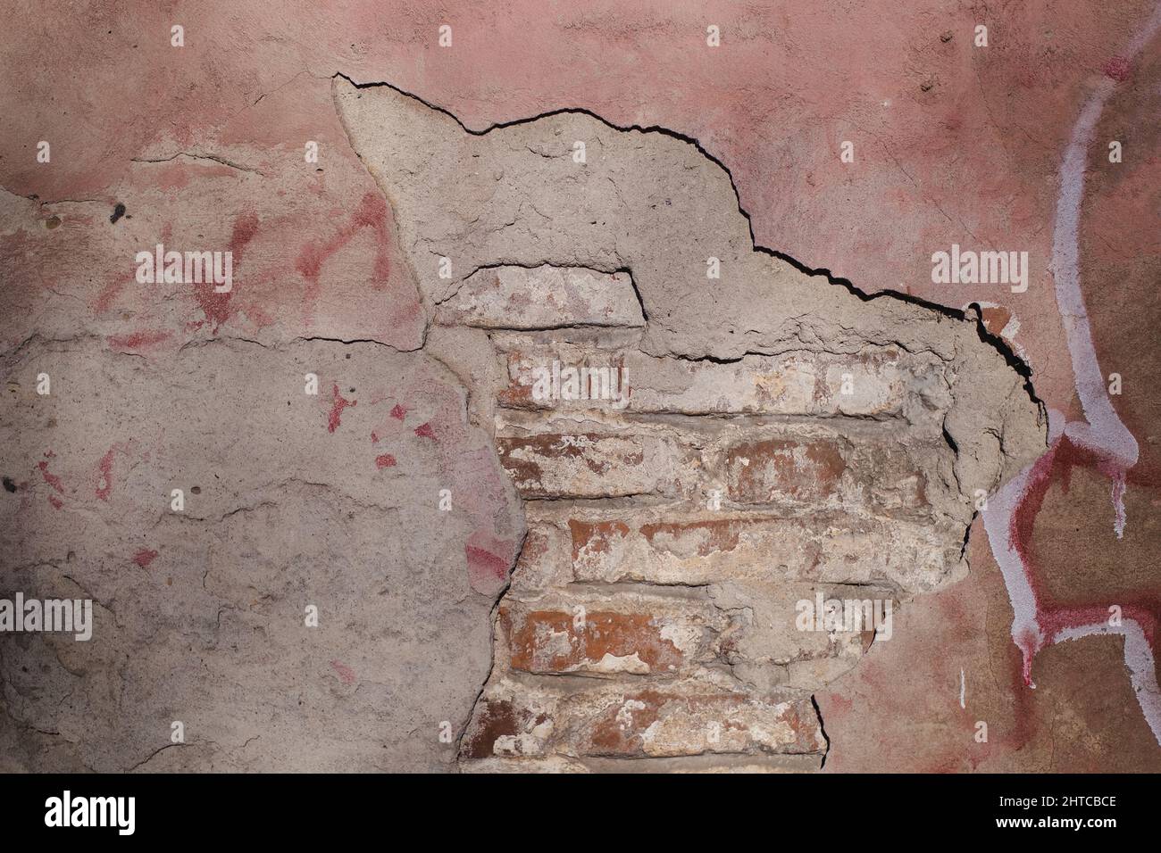 A brick wall with peeling paint and crumbling plaster Stock Photo - Alamy