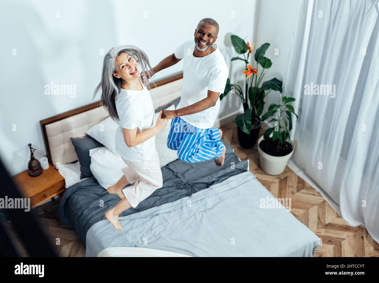 Cinematic image of an happy multiethnic senior couple. Indoors ...