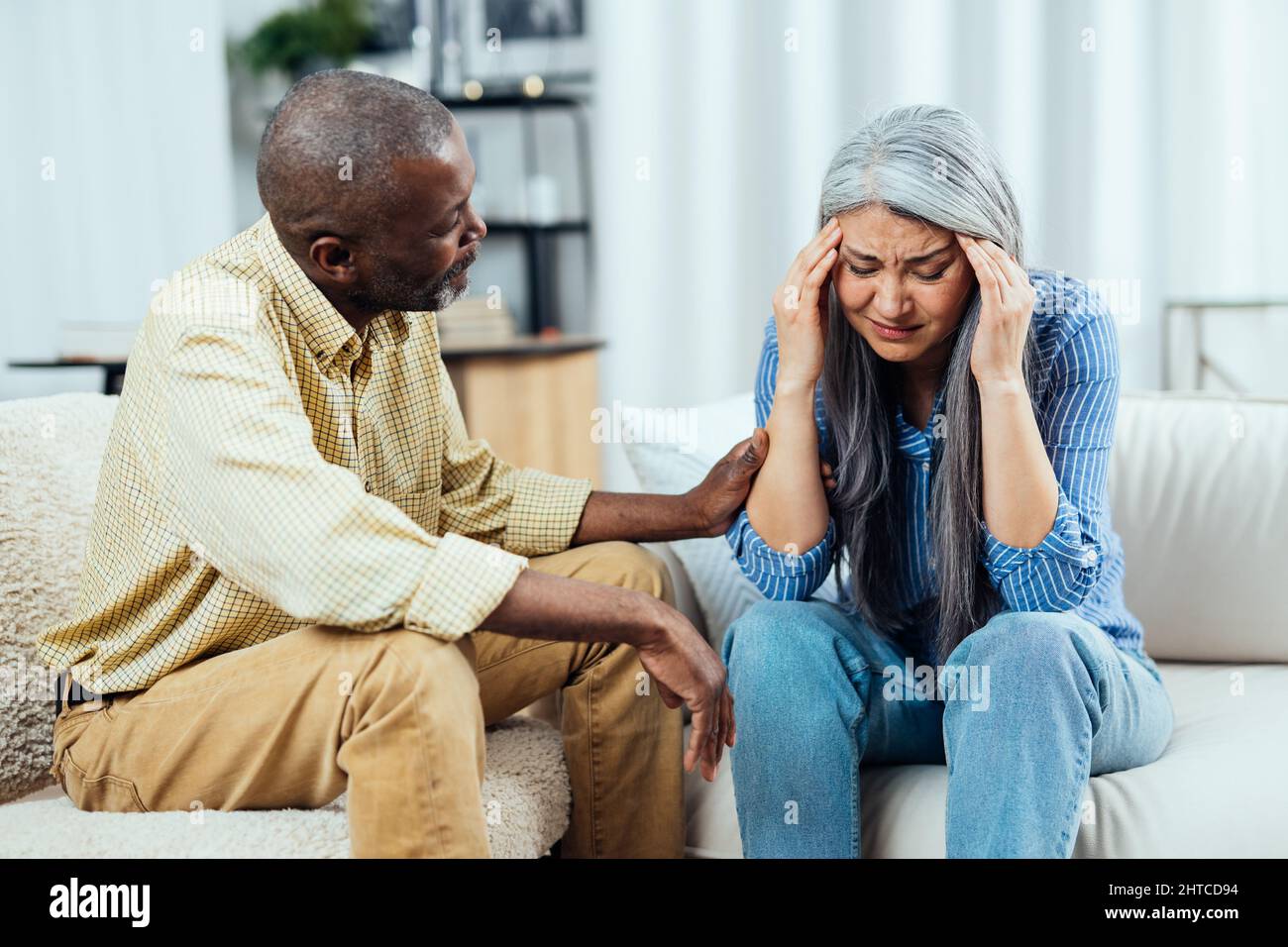 cinematic image of a multiethnic senior couple. Indoors Lifestyle ...