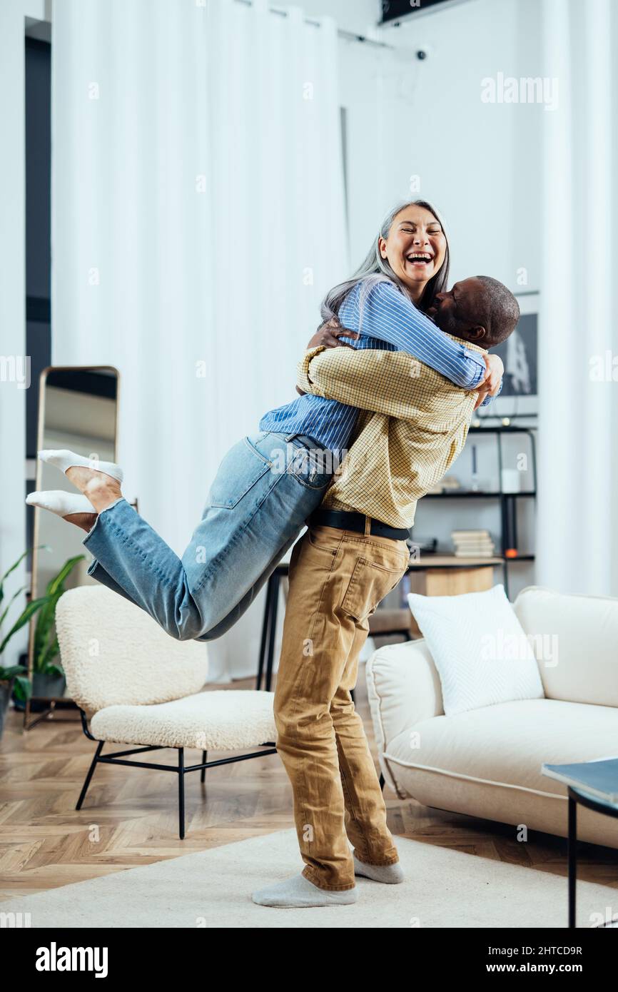 cinematic image of a multiethnic senior couple. Indoors Lifestyle ...