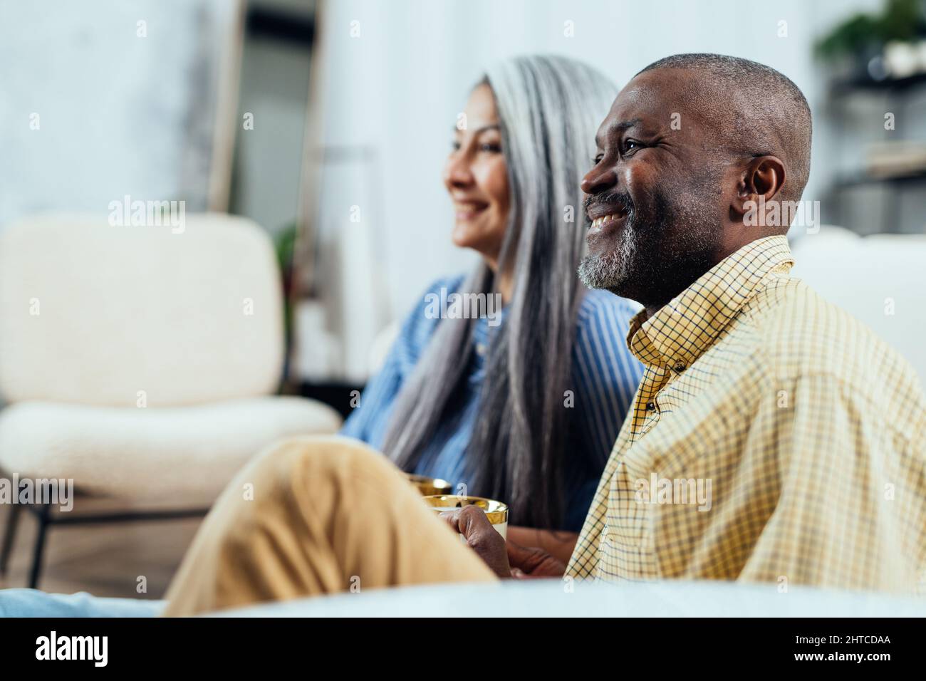 cinematic image of a multiethnic senior couple. Indoors Lifestyle ...