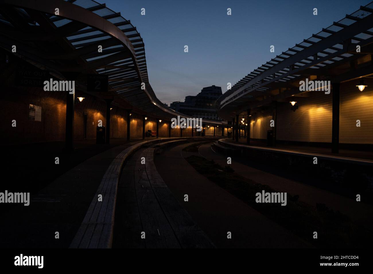 Beautiful view of long wooden platforms with a modern station ceiling ...