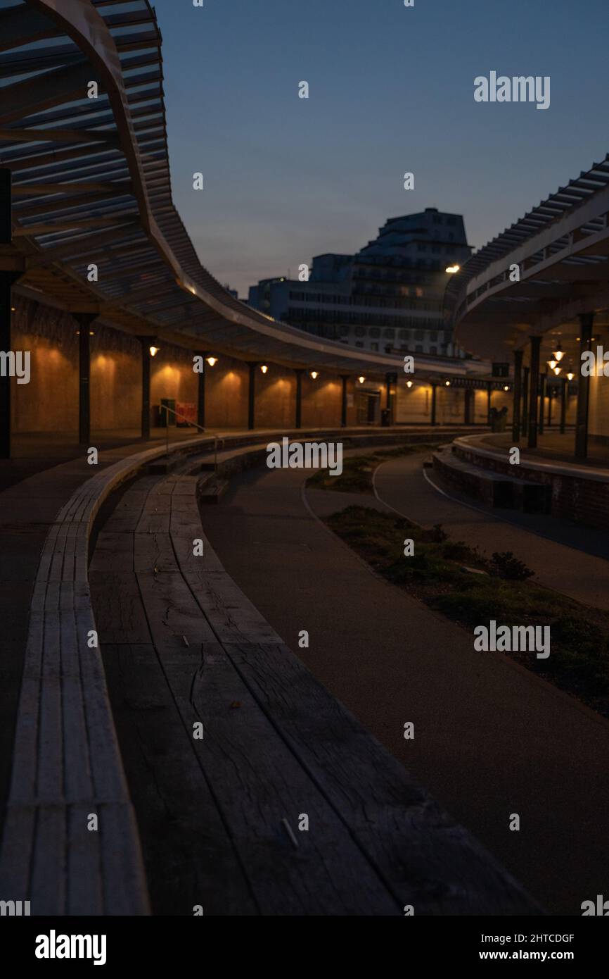 Beautiful view of long wooden platforms with a modern station ceiling ...